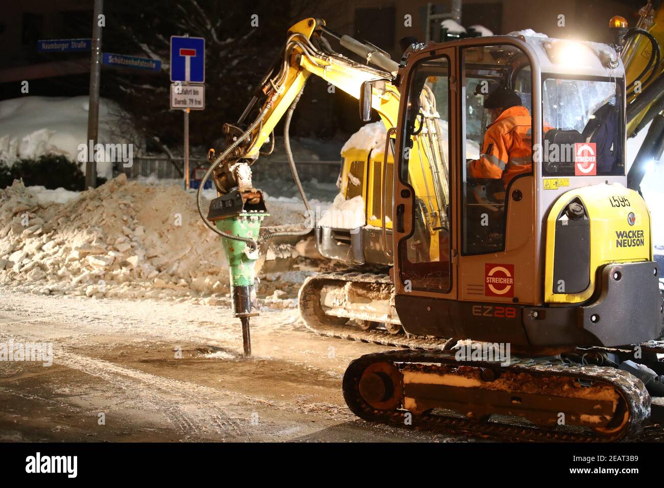 10 February 2021, Thuringia, Jena: Construction workers work at a road ...