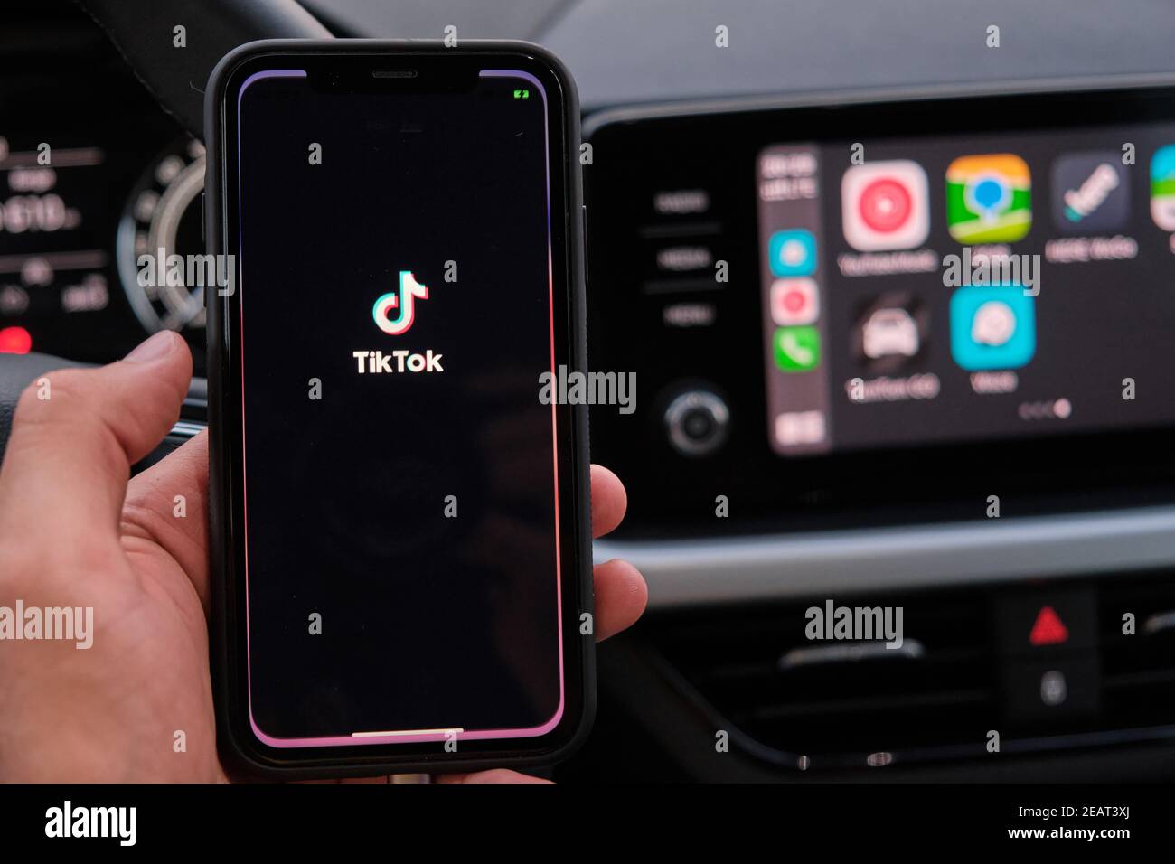 Tik Tok logo on the screen of smart phone in mans hand on the ...