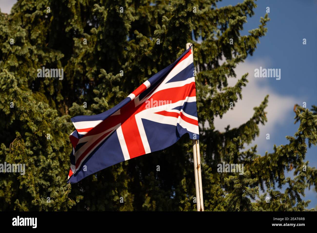 Great Britain flag against blue sky Stock Photo - Alamy