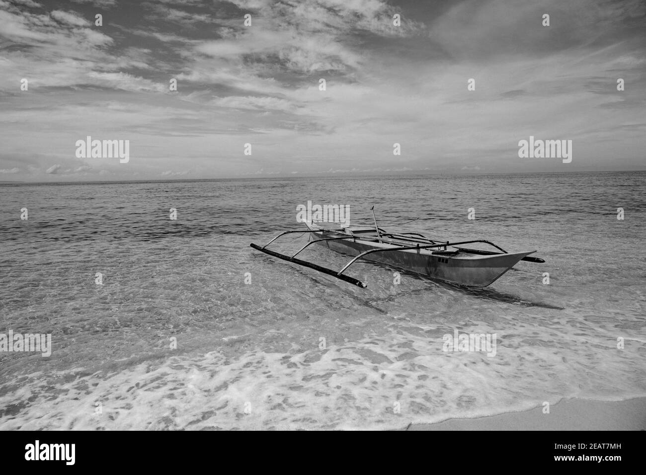 Traditional Filipino boat on a white beach in the sea Stock Photo - Alamy