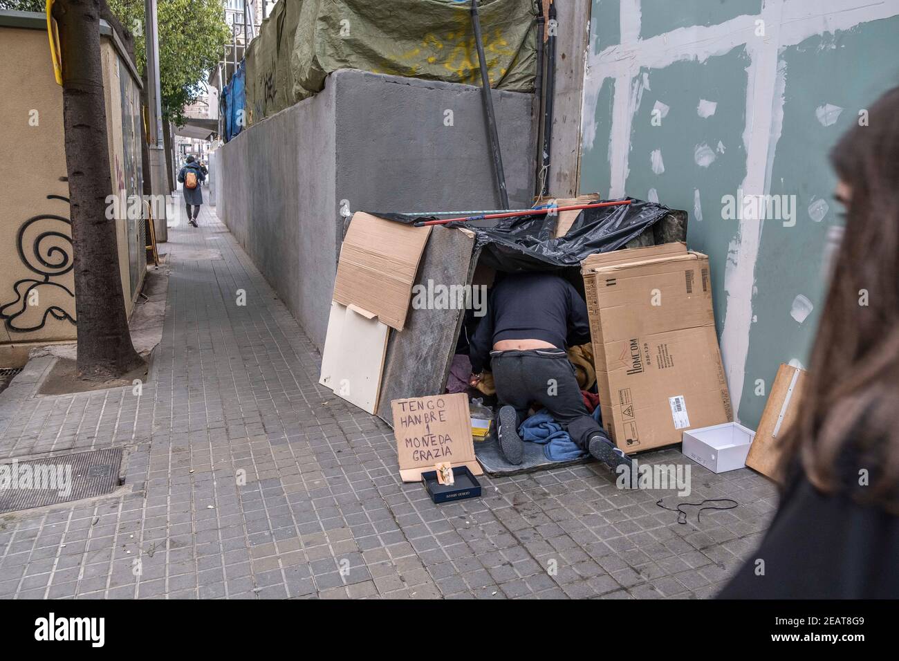 Barcelona, Spain. 10th Feb, 2021. A homeless person is seen tidying up ...