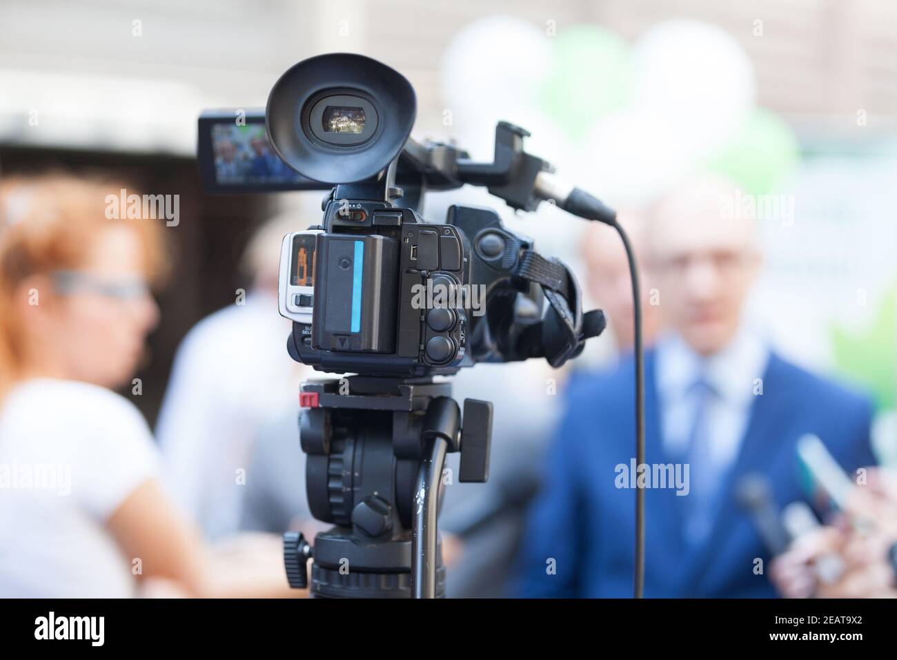 Filming an media event with a video camera. News or press conference ...