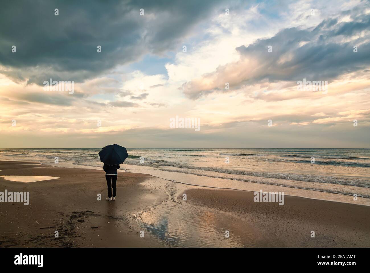 Beach umbrella blowing in wind hi-res stock photography and images - Alamy