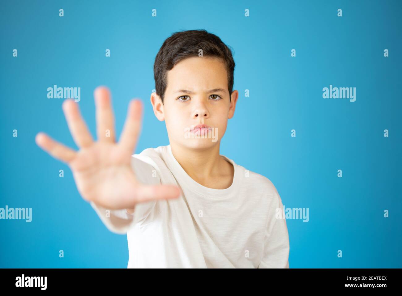 cool young boy showing number five isolated on blue background Stock ...