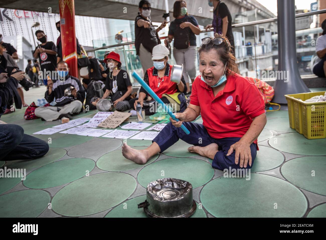 An elderly bangs a cooking pot while shouting slogans during a 'make ...