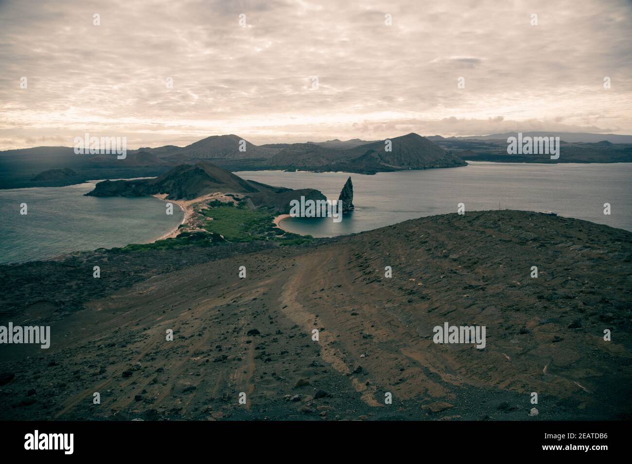 Empty Galapagos landscape with rock spire, bay and hills Stock Photo ...