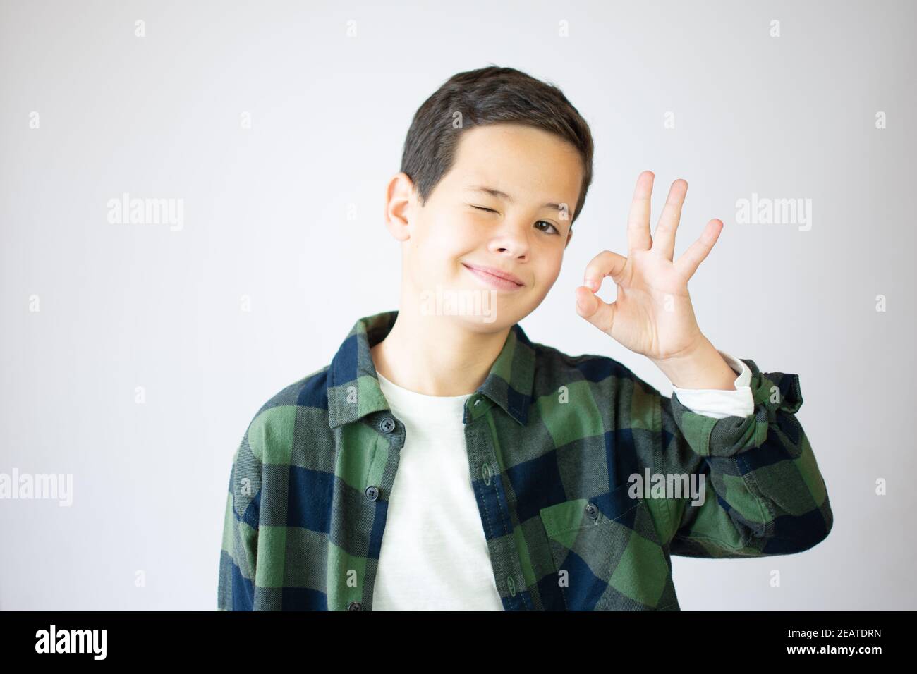 Boy showing okay gesture in sign language on white background Stock ...