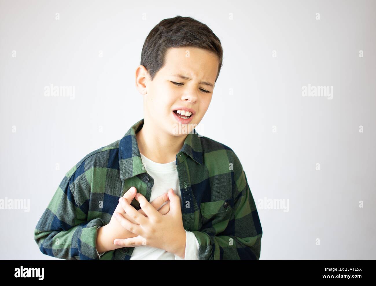 Young boy with pain gesture over white background Stock Photo - Alamy