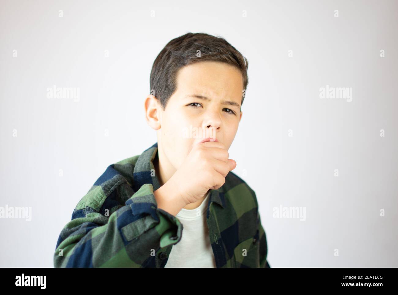 Young boy with pain gesture over white background Stock Photo - Alamy