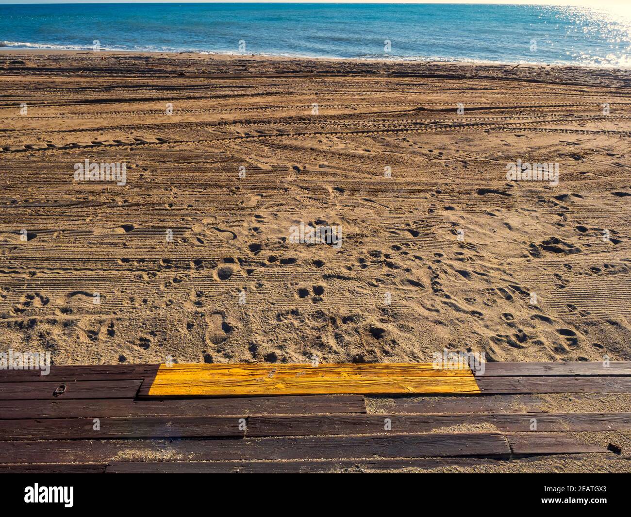 Wooden steps painted in yellow in front of the sea Stock Photo - Alamy