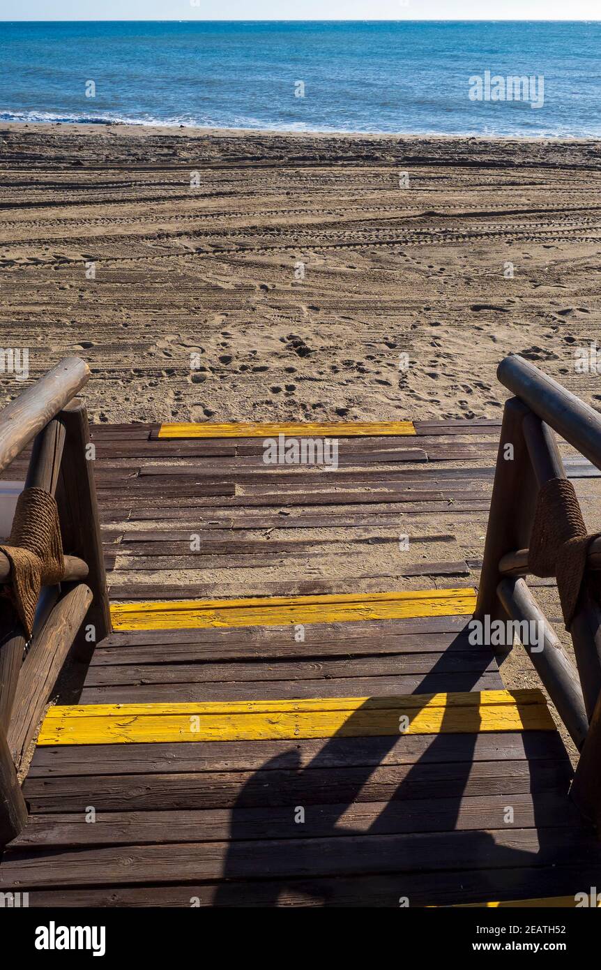 Wooden steps painted in yellow in front of the sea Stock Photo - Alamy