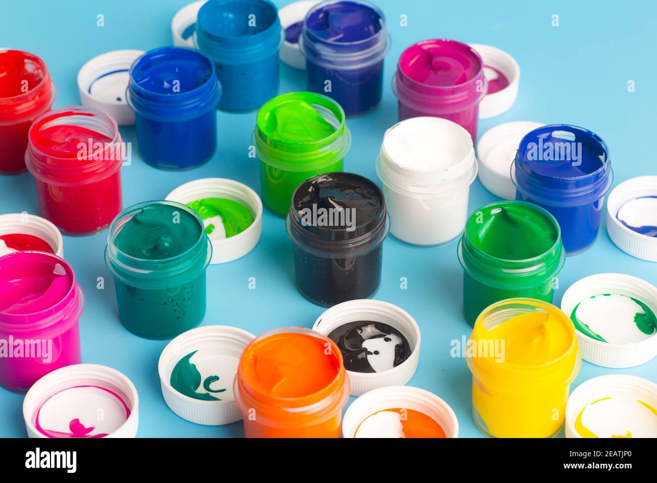 Acrylic paints of various colors for drawing are open on the table ...