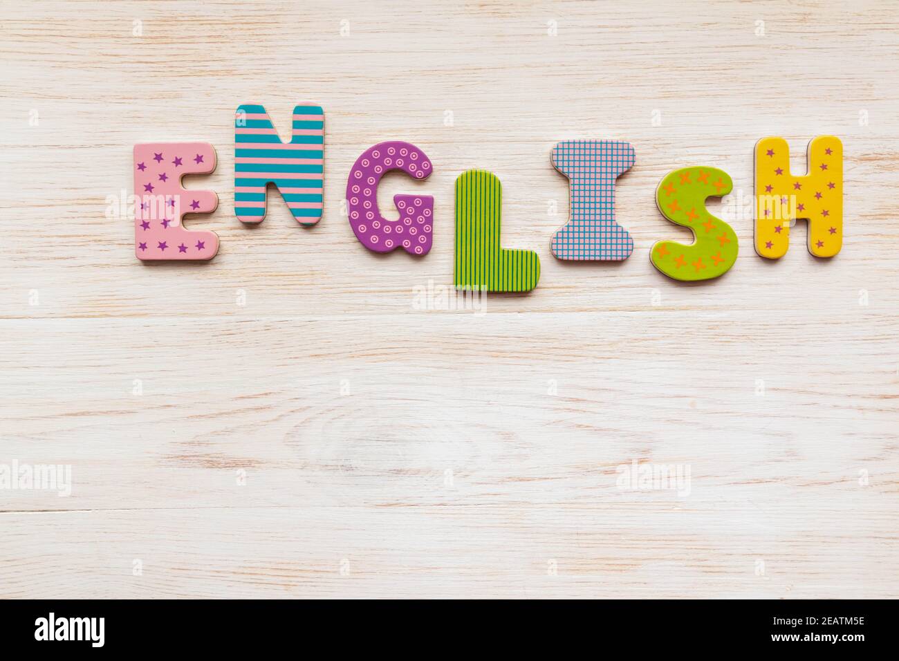 Word English made of colorful wooden letters on vintage white painted ...