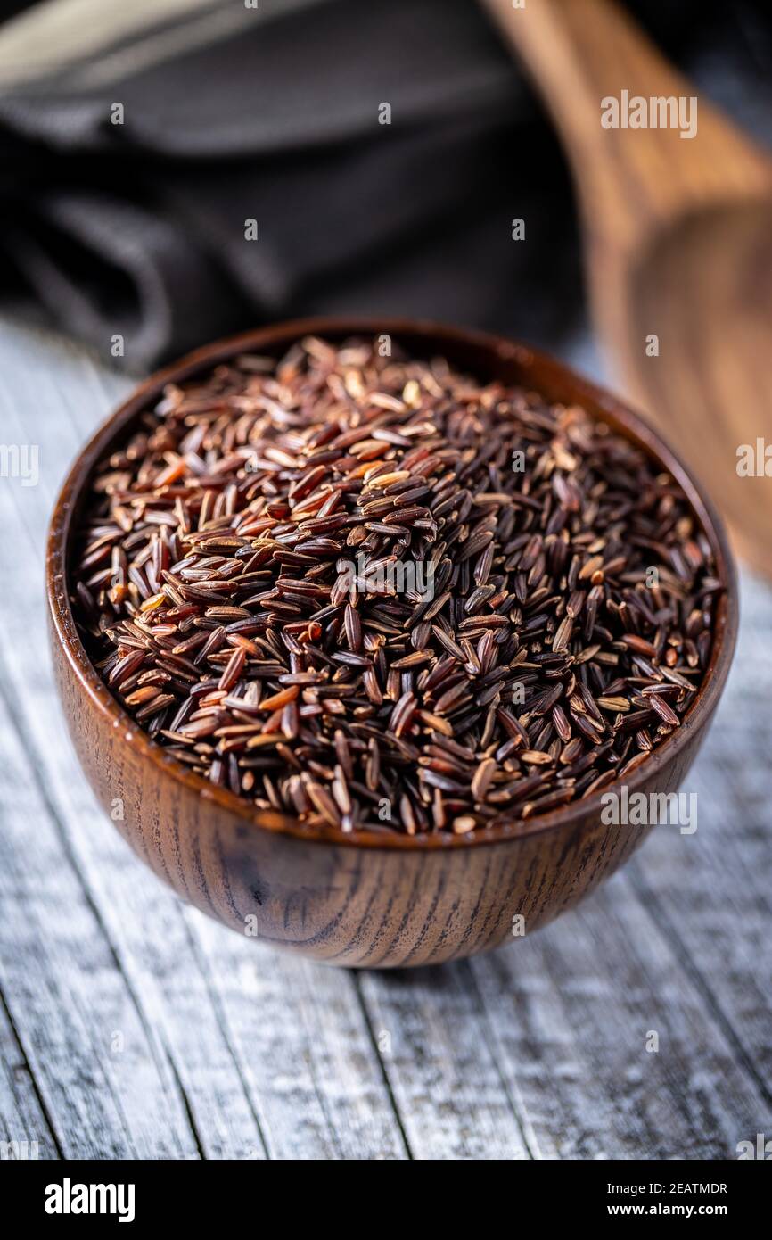 Uncooked red rice. Raw wild rice Stock Photo - Alamy