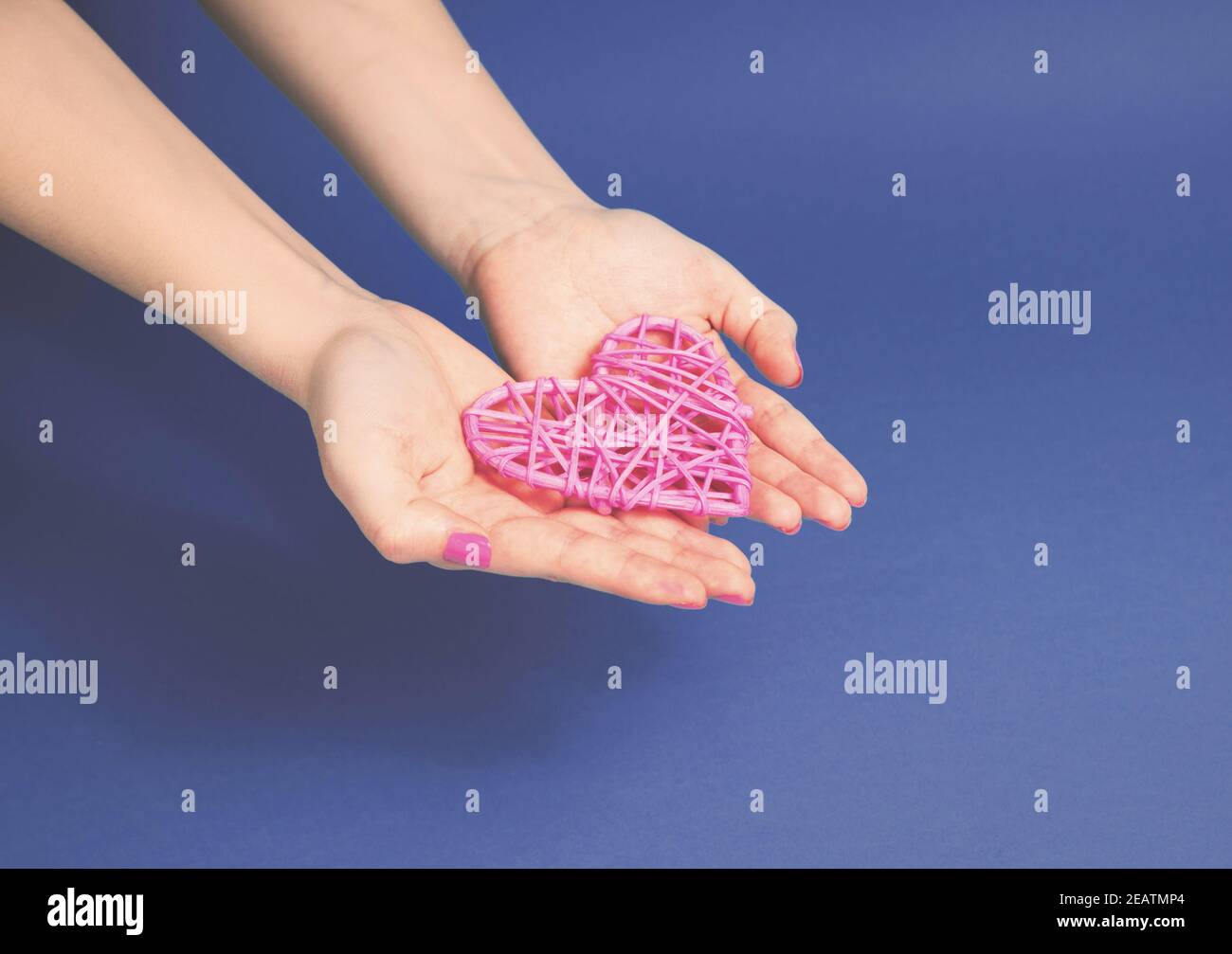 Heart on women's hands, giving love kind and support Stock Photo - Alamy