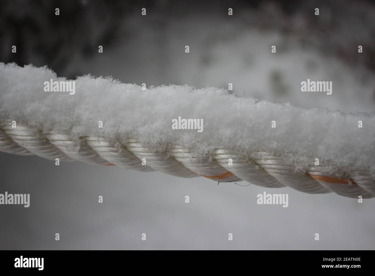 Snow flakes on rope in winter snowfall Stock Photo - Alamy