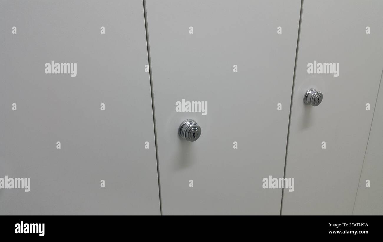Perspective view of lockers or cupboards in a row with white doors ...