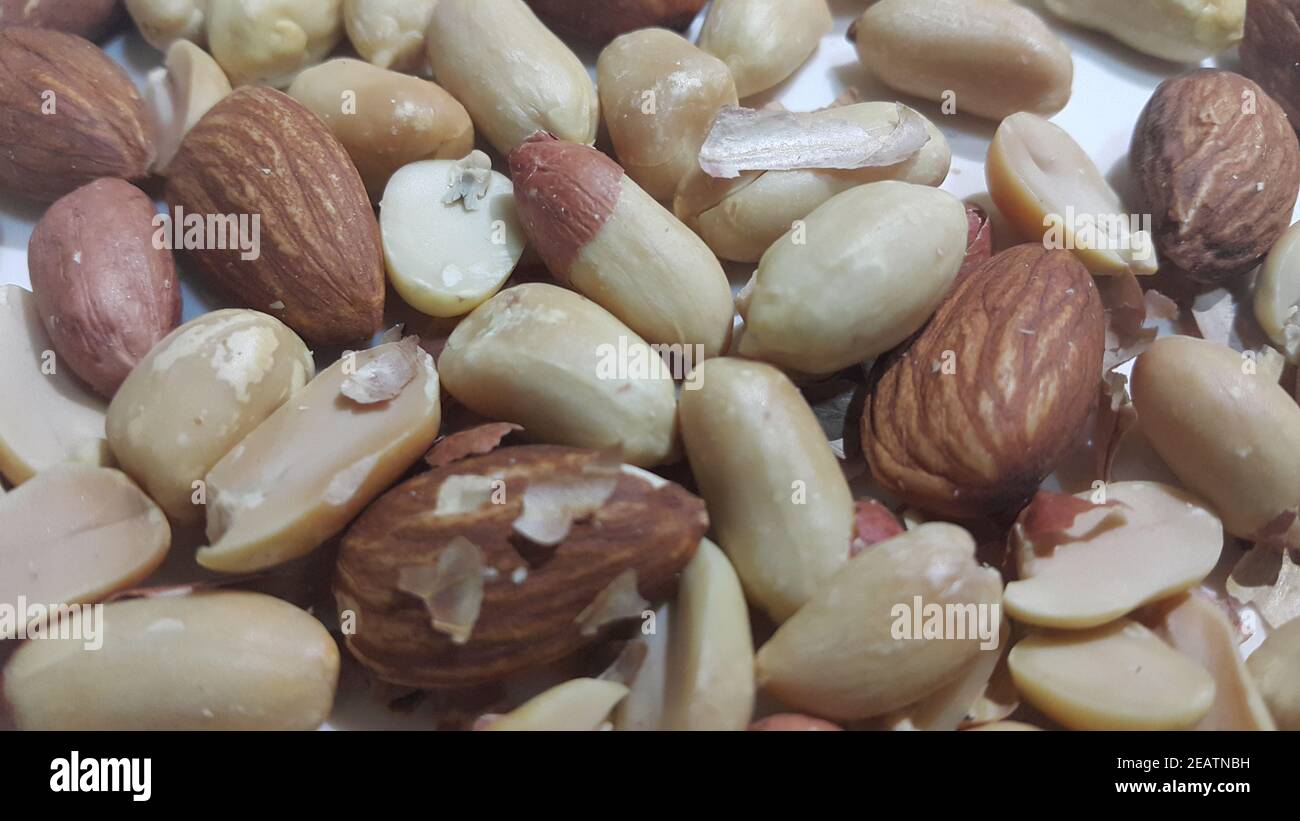 Dried and roasted peanuts and almonds out of shell. A fruit for ...