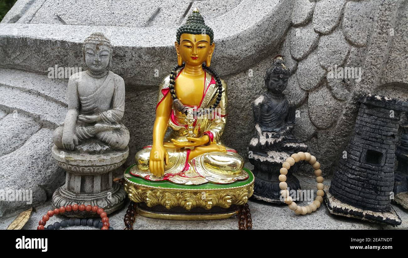Buddha mini statue with beautiful background Stock Photo - Alamy