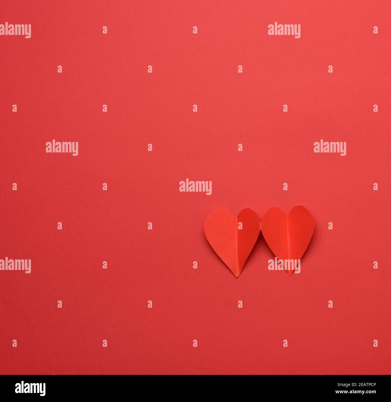 two paper hearts on a red background Stock Photo - Alamy