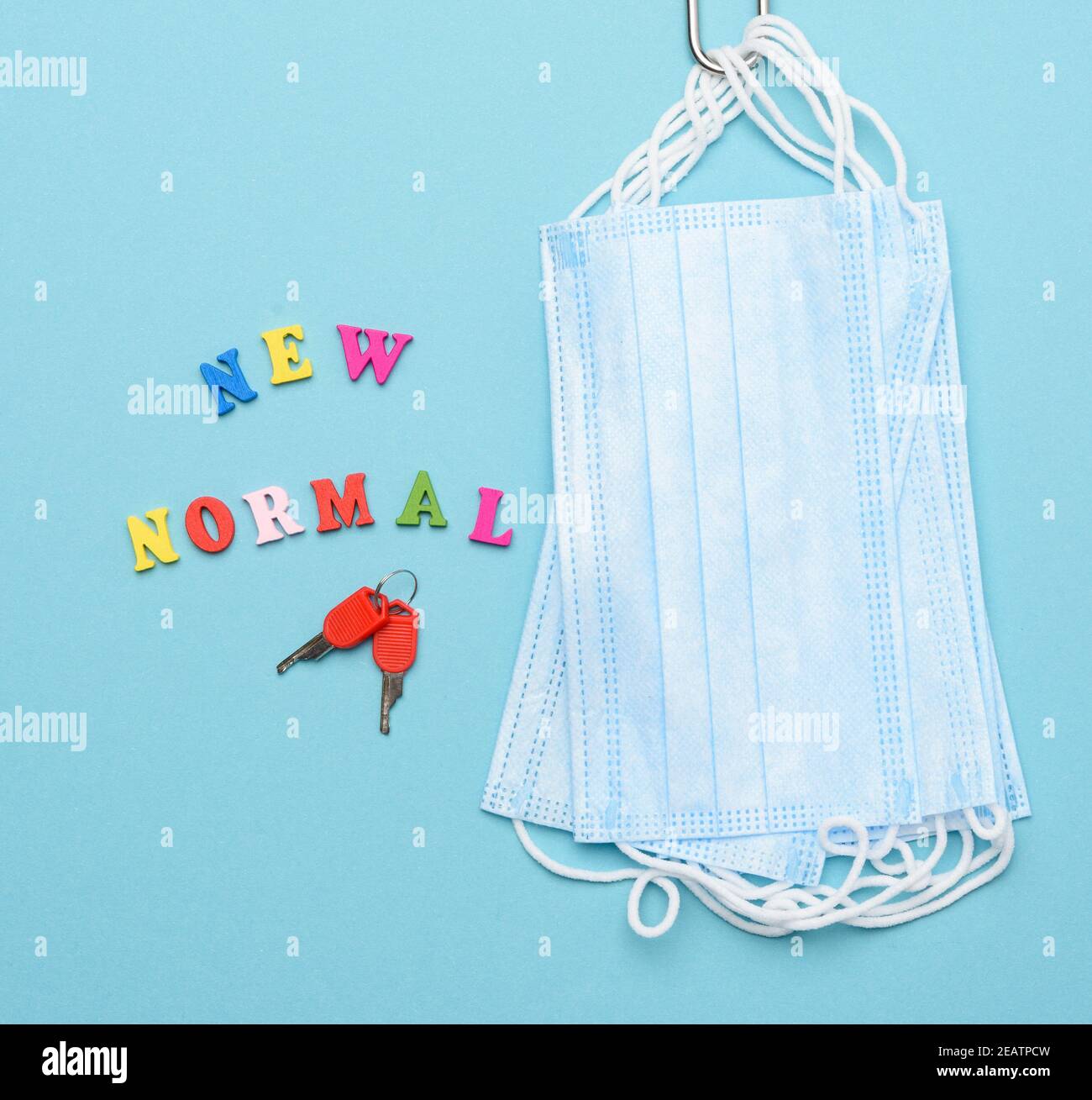 stack of disposable masks and a metal lock on a blue background Stock ...