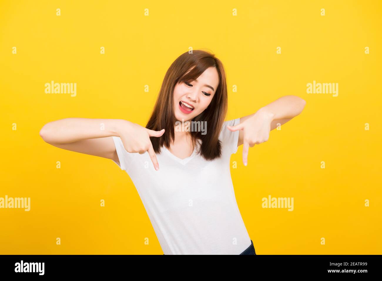 woman teen standing makes gesture two fingers point below Stock Photo ...