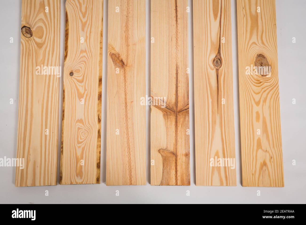 Unfinished raw pine lumber on a solid white background Stock Photo - Alamy