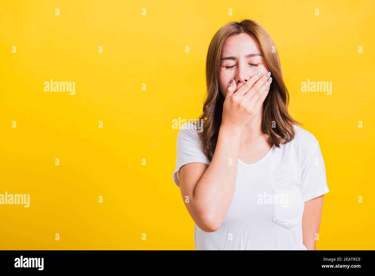 woman emotions tired and sleepy her yawning close mouth open by hand ...