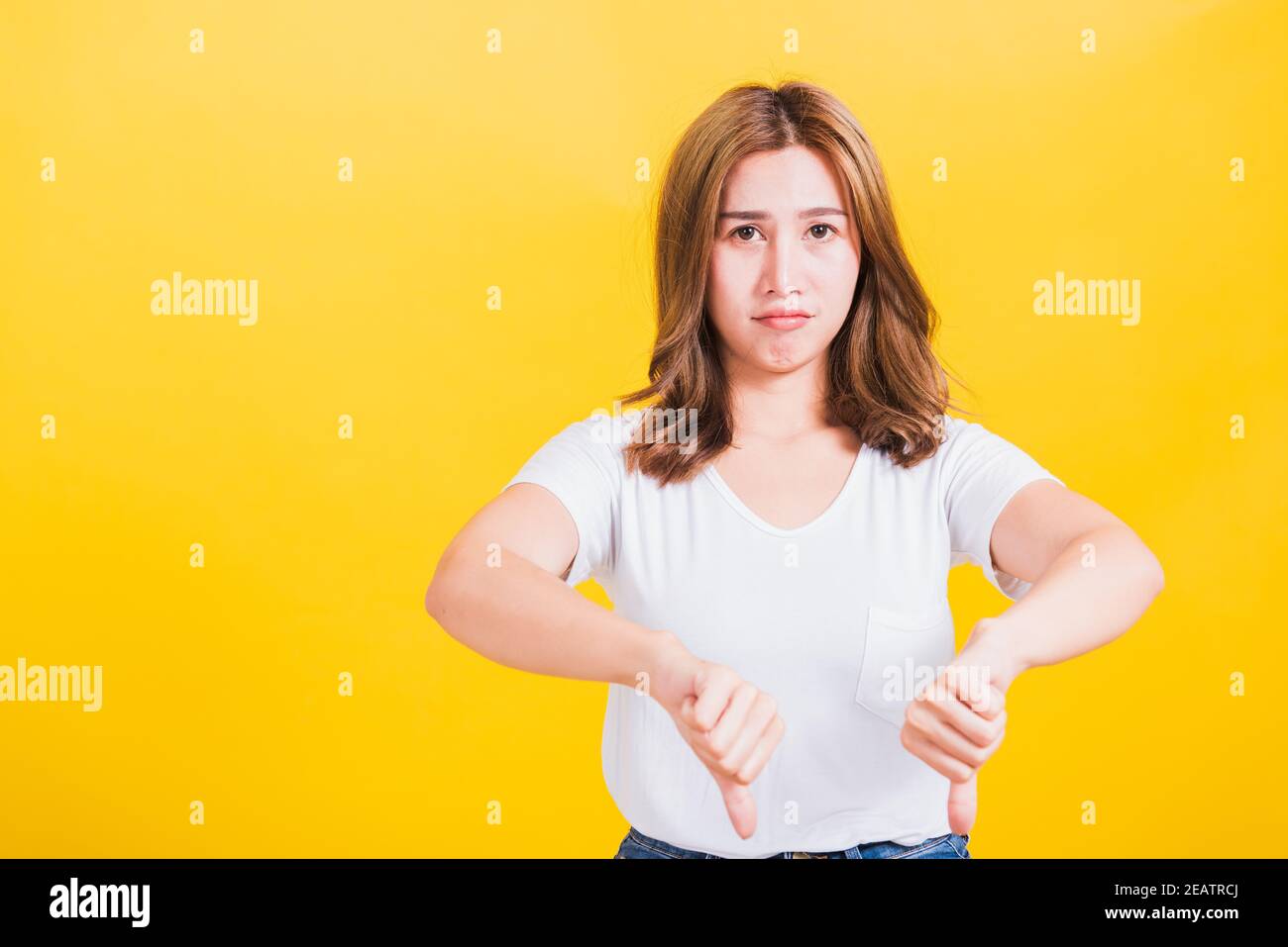 woman unhappy, a negative gesture showing finger thumbs down Stock ...