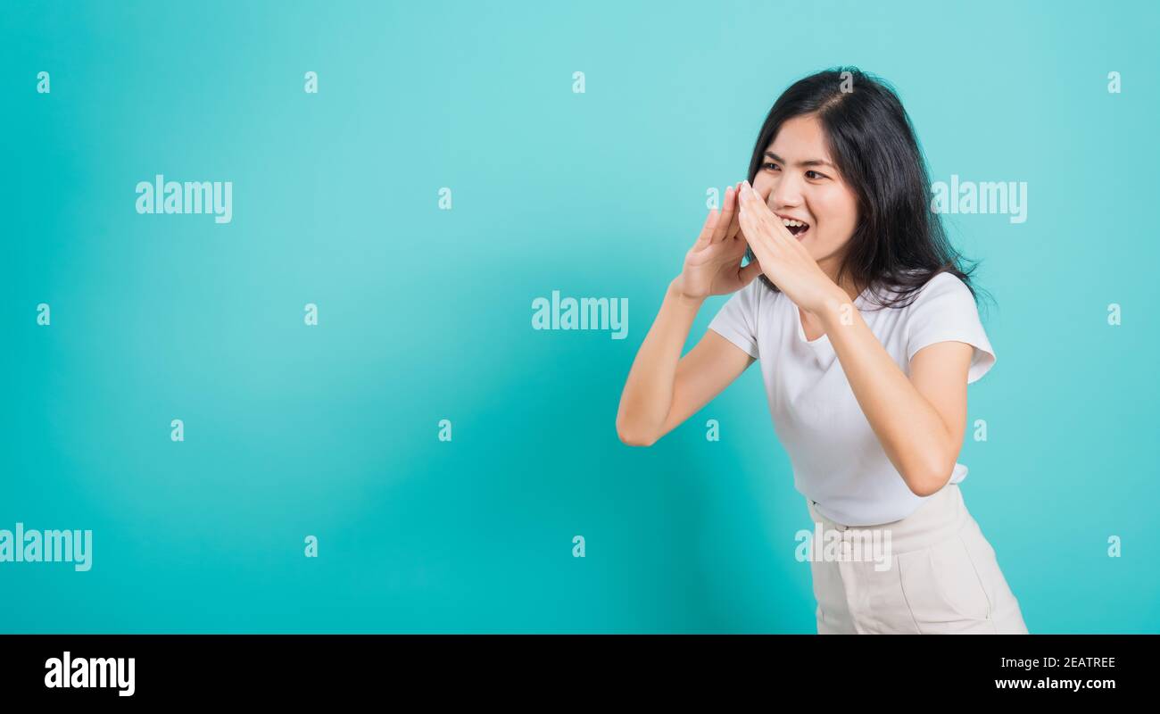 woman smile wear white t-shirt standing shouting with hands cover mouth ...