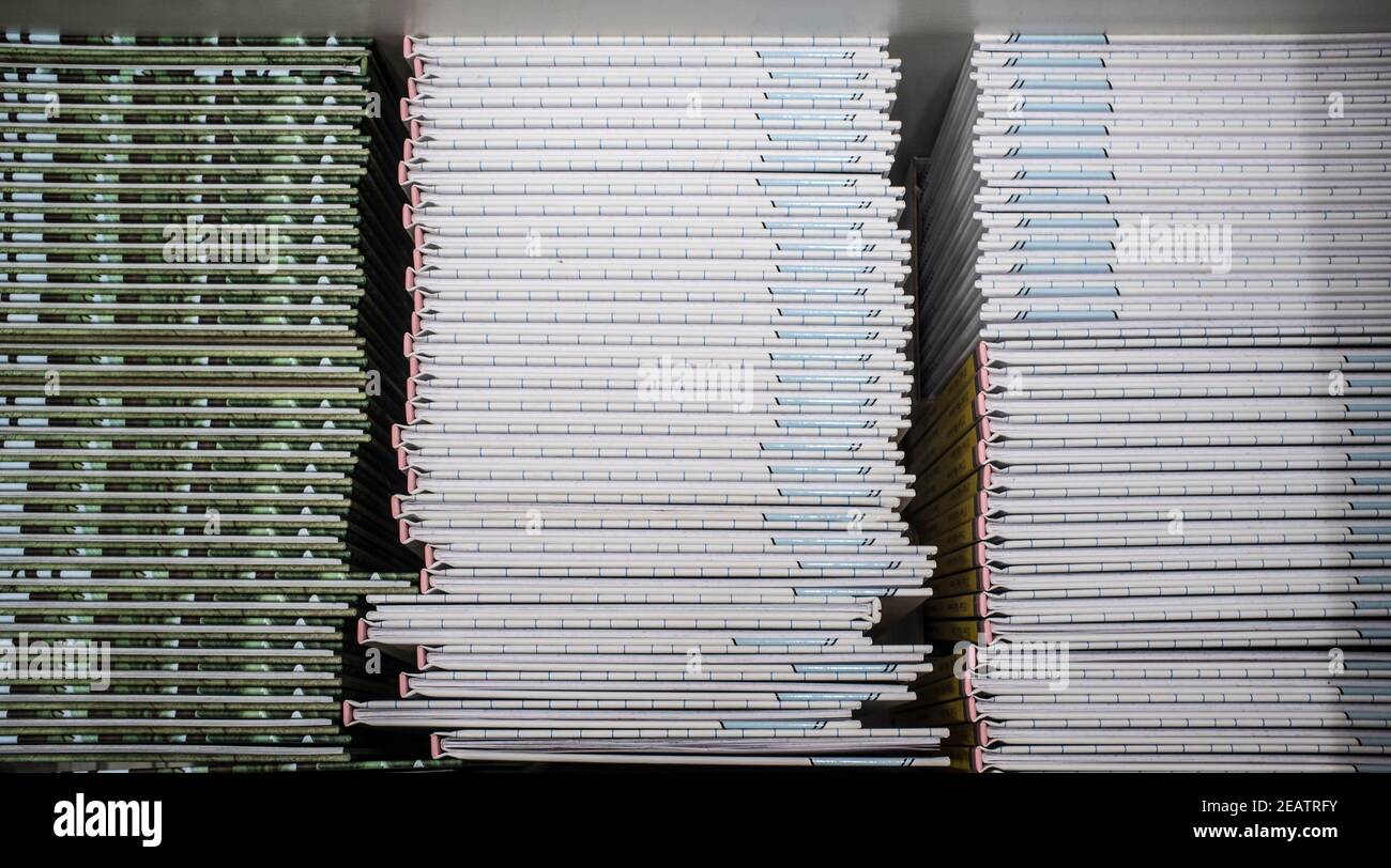 Three piles of new commercial print catalogues Stock Photo - Alamy