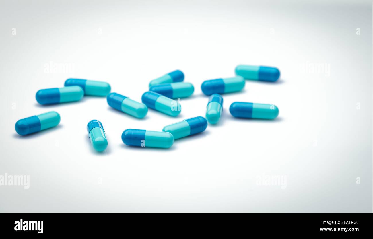 Selective focus on blue capsule pills. Group of capsule pills with ...