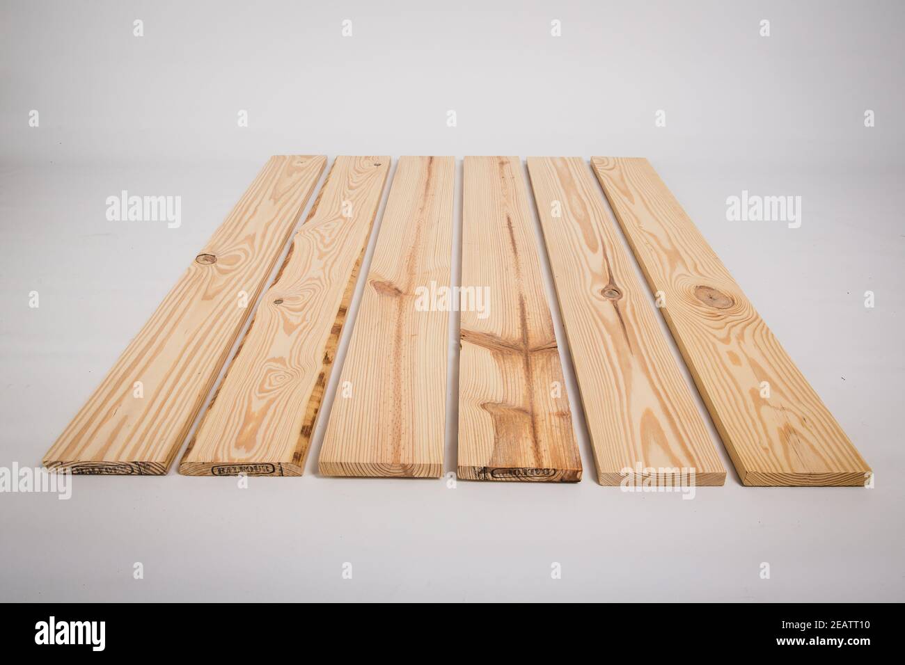 Unfinished raw pine lumber on a solid white background Stock Photo - Alamy