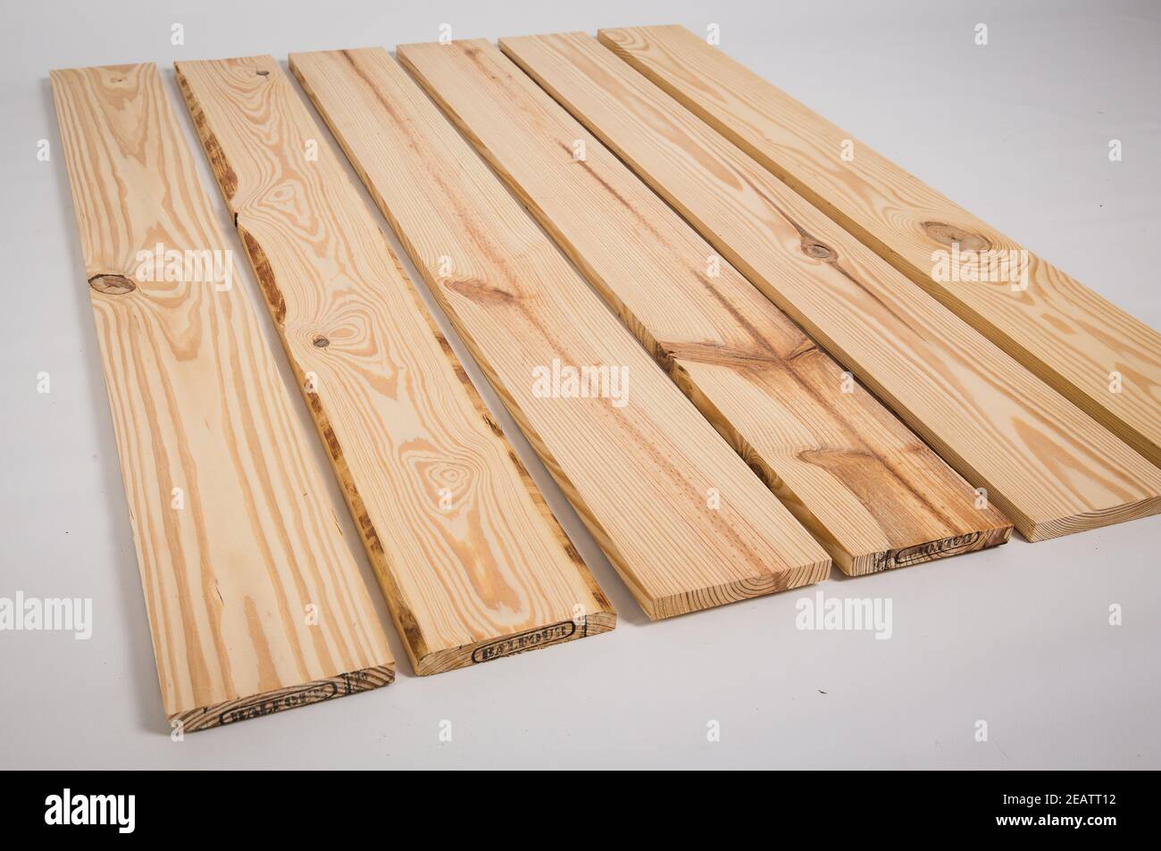 Unfinished raw pine lumber on a solid white background Stock Photo - Alamy