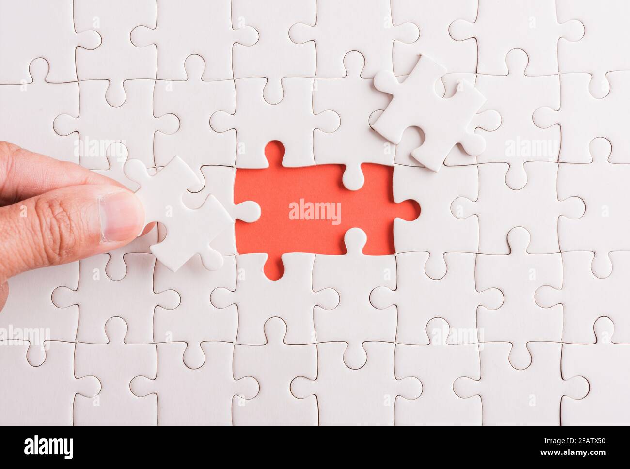 hand-holding last piece white paper jigsaw puzzle game last pieces put ...