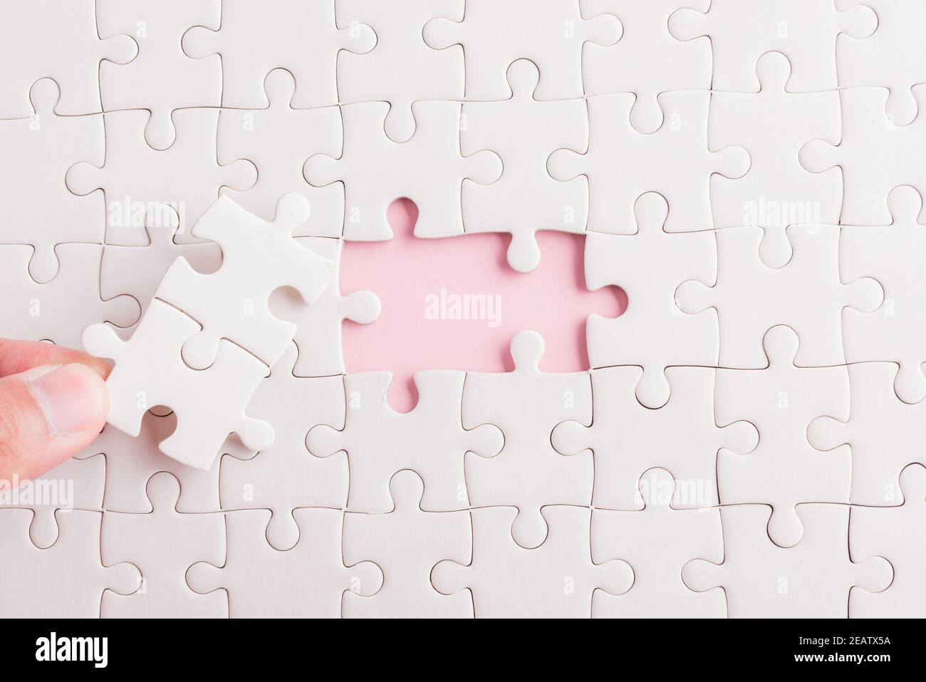 hand-holding last piece white paper jigsaw puzzle game last pieces ...