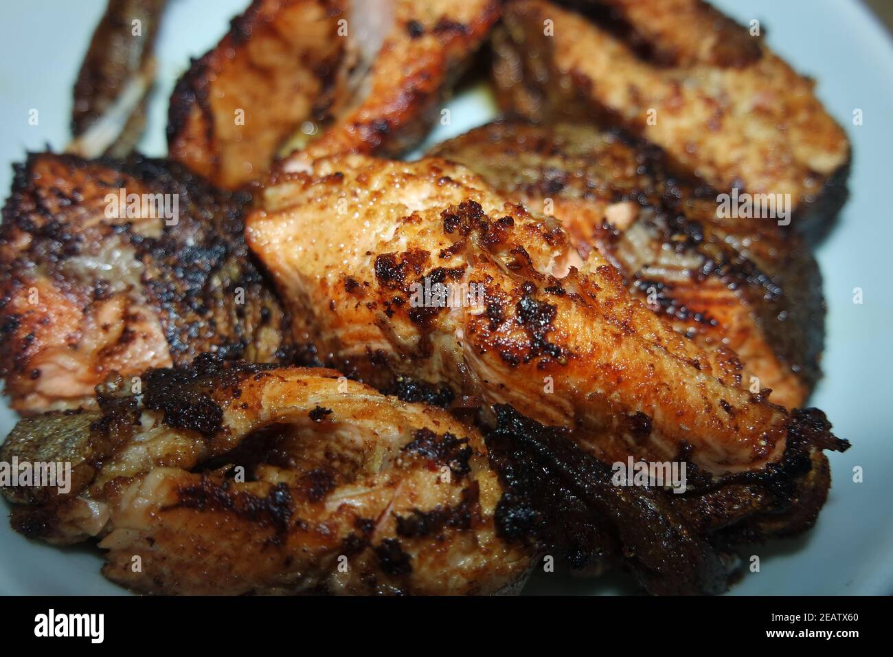 Spicy and crunchy barbecue of fried fish fillet on a white background ...