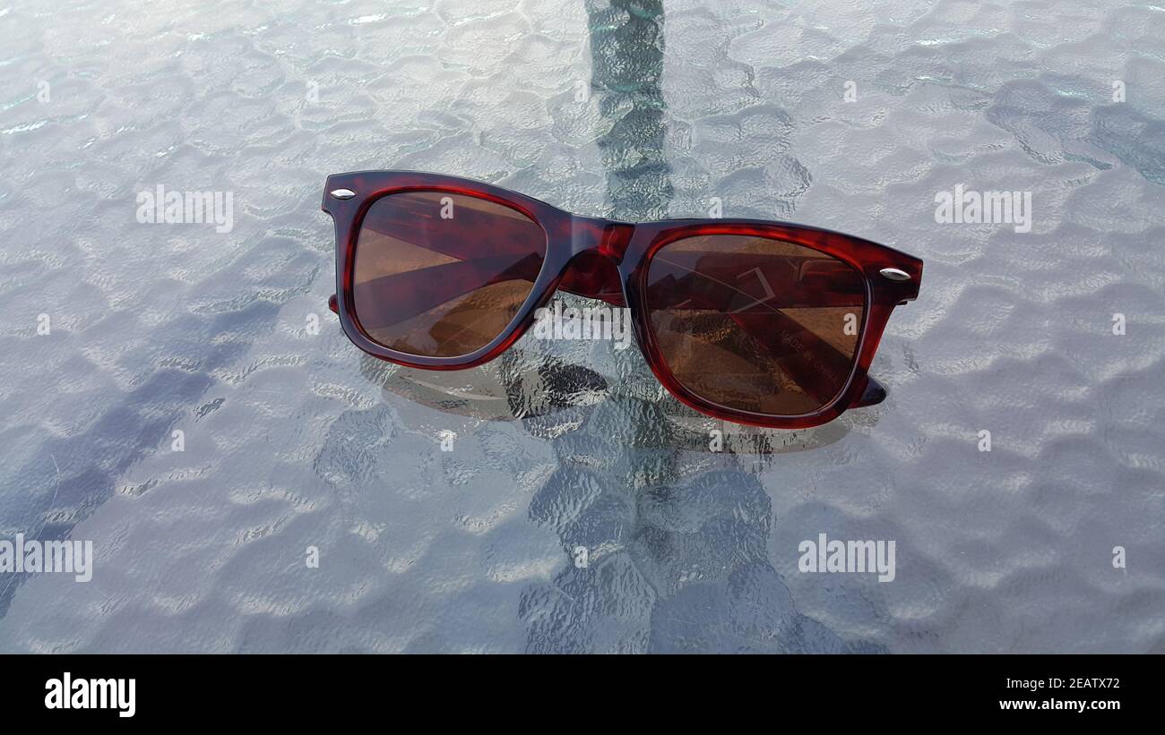 Eye glasses or spectacles on glass floor or table Stock Photo - Alamy