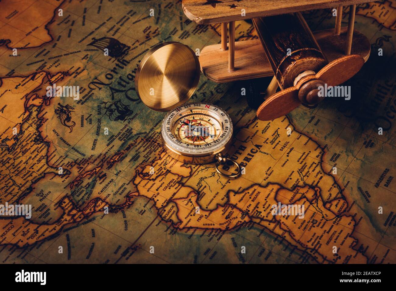 Old compass discovery and wooden plane on vintage paper antique world ...