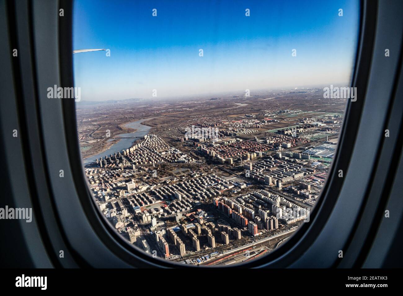 Beijing skyline visible from the window of an airplane Stock Photo - Alamy