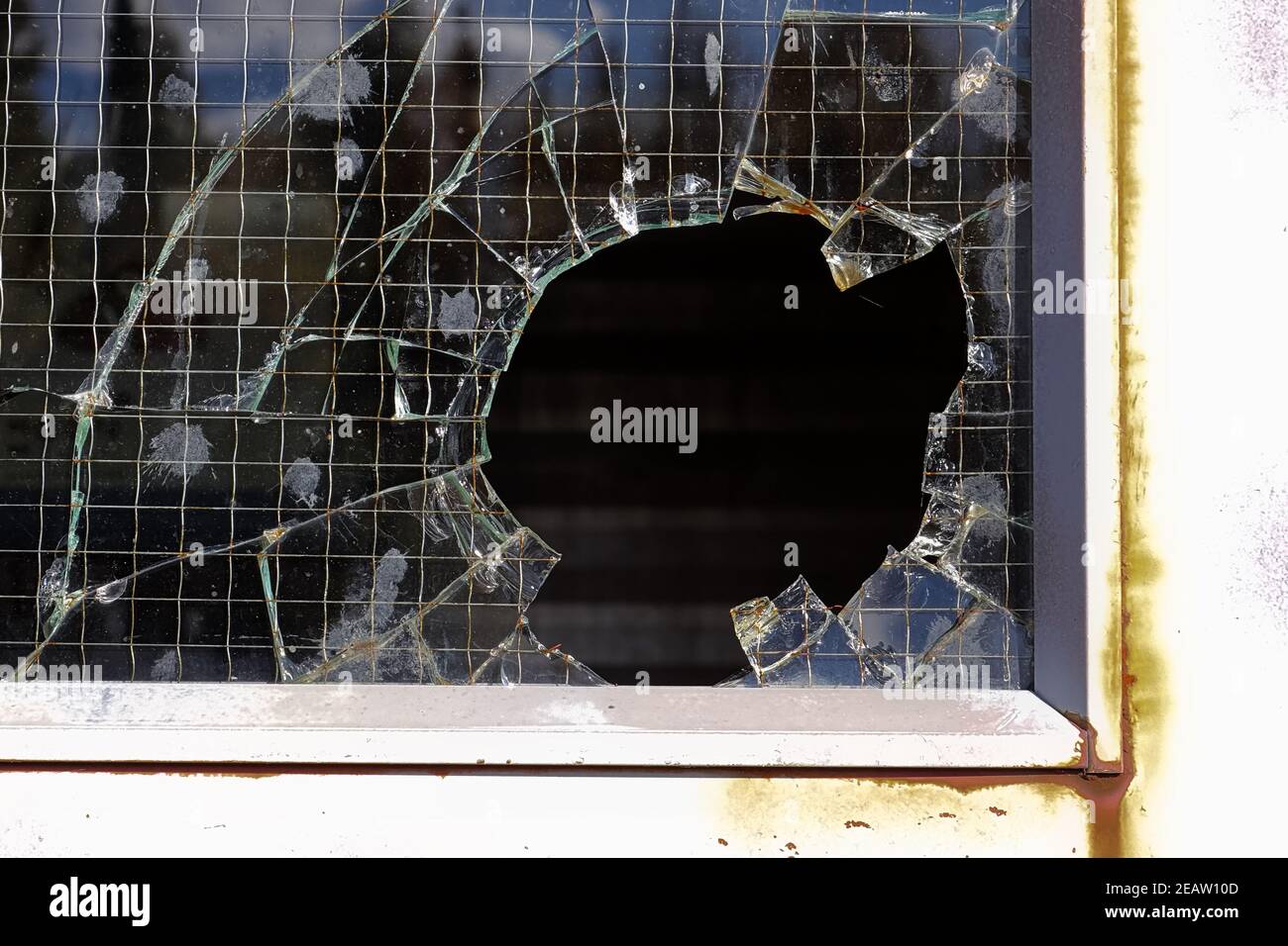 Closeup of a break-in through a wired glass window Stock Photo - Alamy