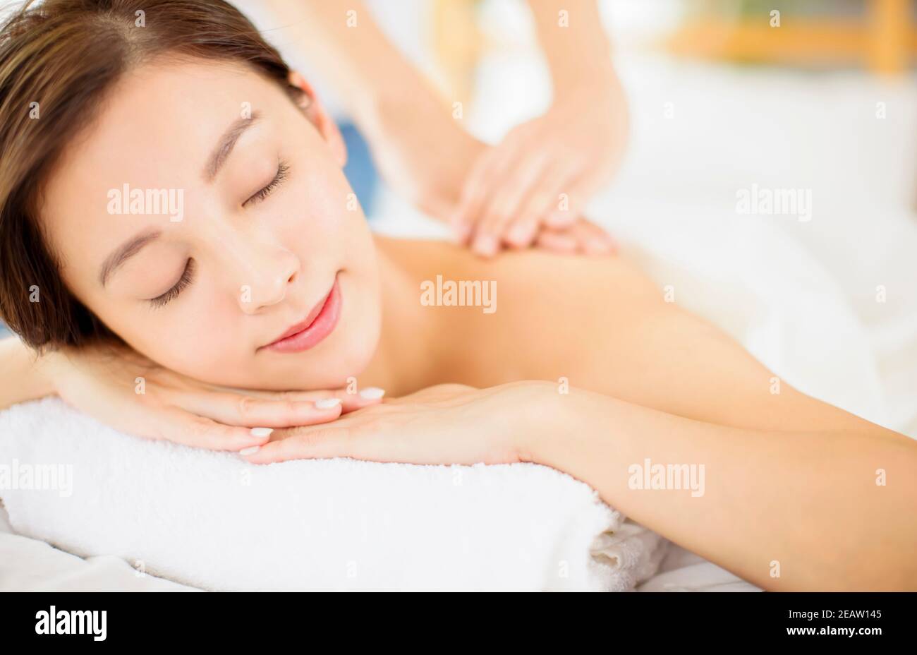 relaxed Young woman enjoy massage in spa salon Stock Photo - Alamy