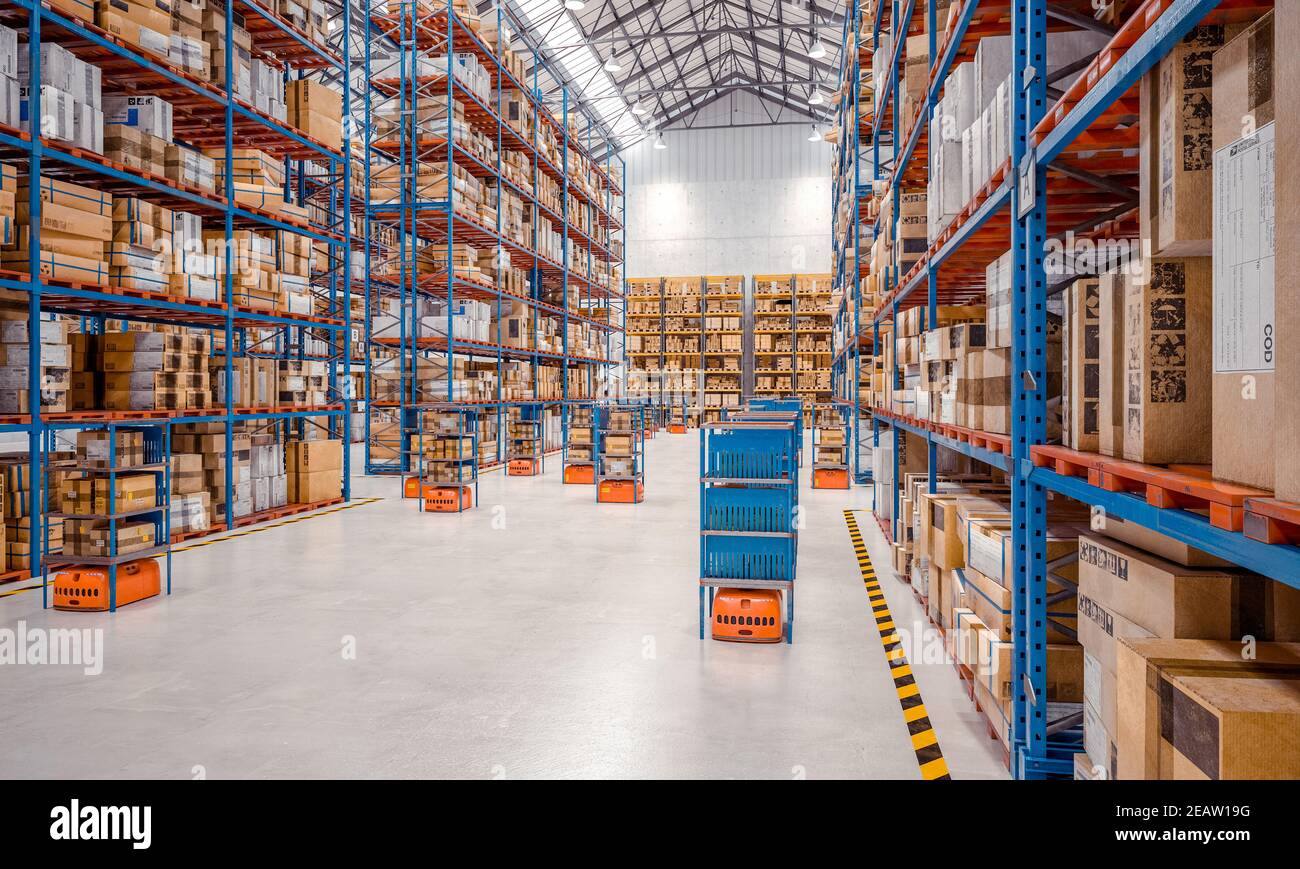 interior of a modern warehouse where automated goods transport vehicles ...