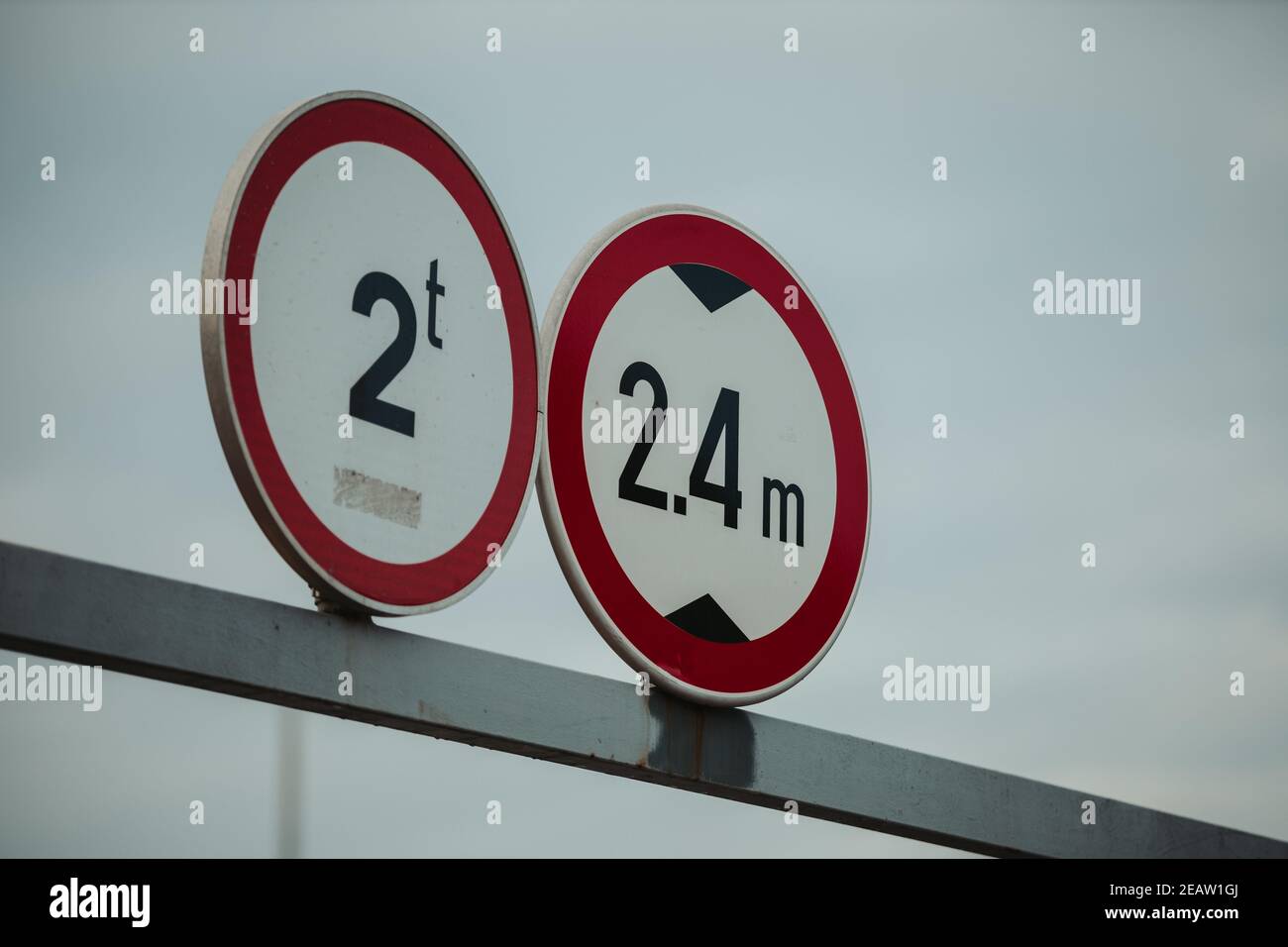 Low angle shot of weight control and height restriction road signs ...