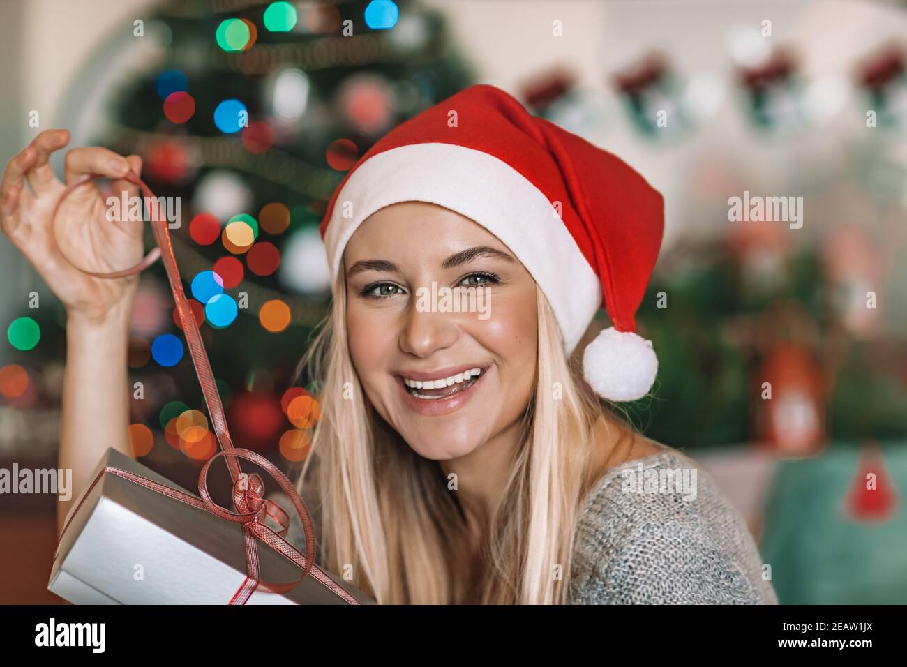 Happy Woman Opening Gift Box Stock Photo - Alamy