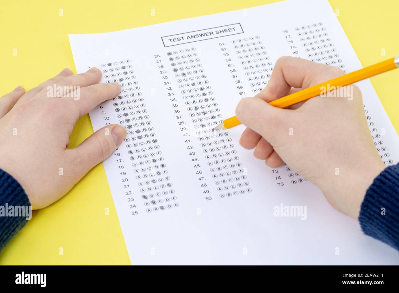 Exam. Filling in the test with a pencil Stock Photo - Alamy