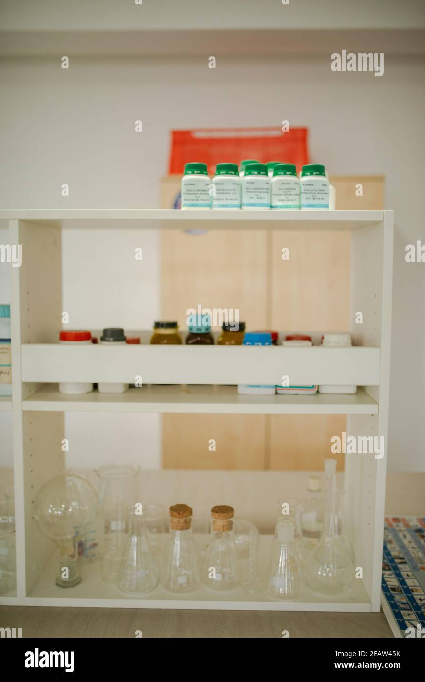 Test tubes and some bottles in a laboratory on shelves Stock Photo - Alamy