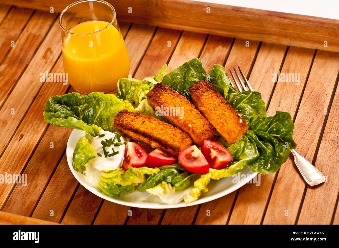 Fish fingers served with salad Stock Photo - Alamy