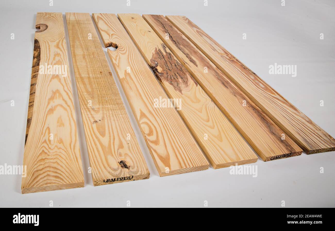 Unfinished raw pine lumber with light and dark color variation on a ...