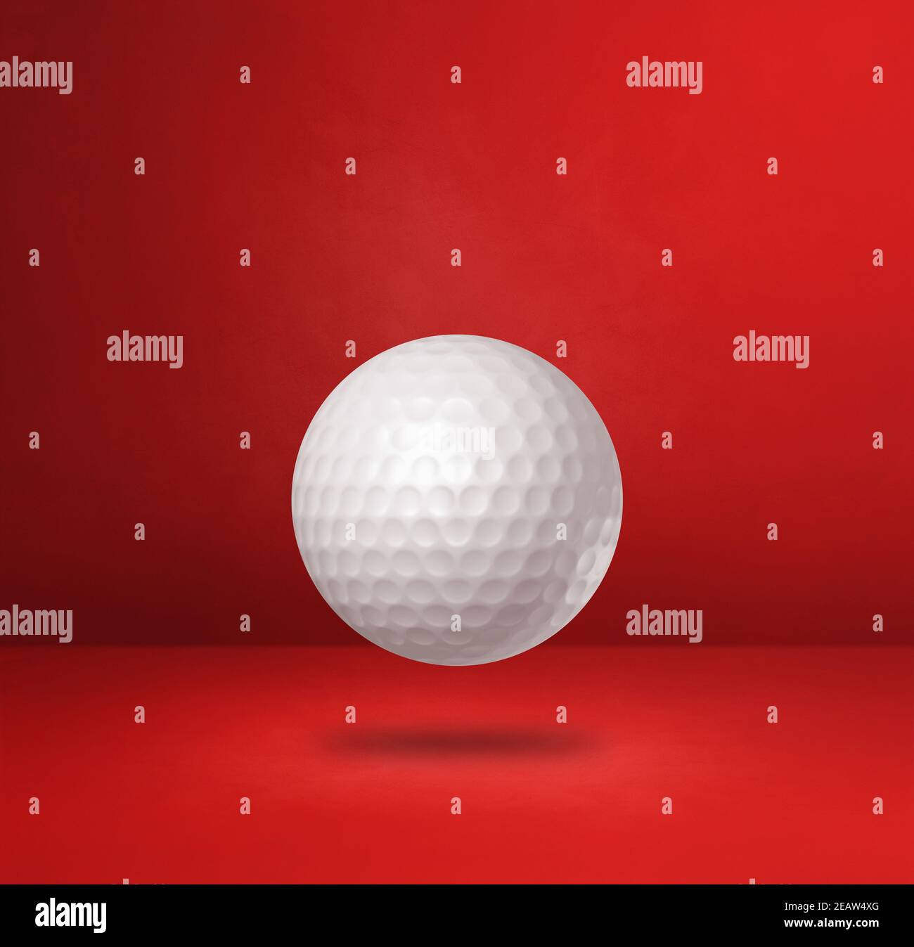 White golf ball on a red studio background Stock Photo - Alamy